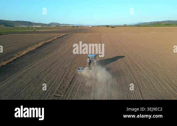 Aerial View of Tractor Plowing Brown Soil in Agricultural Field ...
