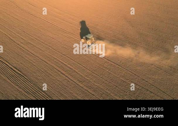 Aerial View of Tractor Plowing Brown Soil in Agricultural Field ...