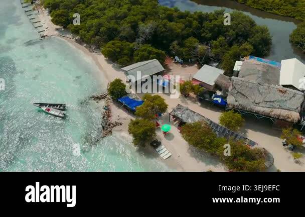 Drone aerial orbit of Isla Mucura at 45 degree angle showing beach ...