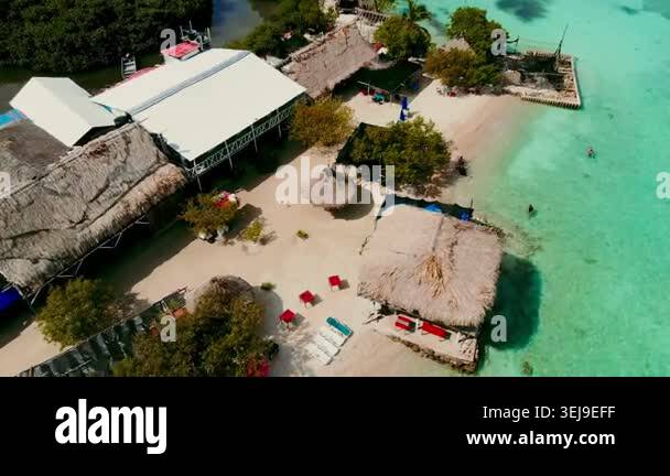 Aerial drone view of Mucura Island beach with tourists and palm trees ...