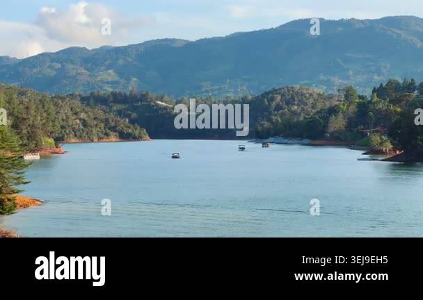 Horizontal telephoto video of Guatape reservoir with motorboats static ...