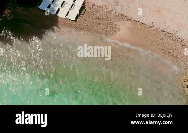 Drone close view of Mucura Island beach with foam and sand movement ...