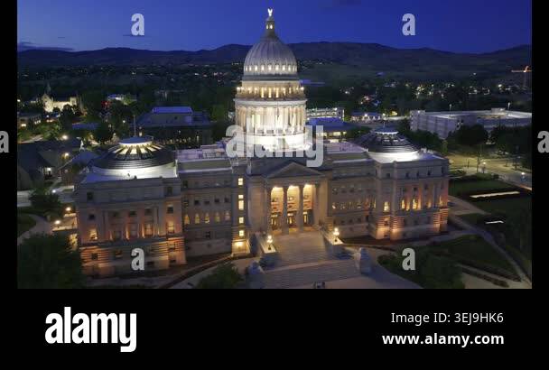 The idaho Capitol building glows at dusk with a panning shot. Its dome ...