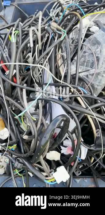 Pluggy cable scrap from an e-waste recycling plant. High quality 4k ...