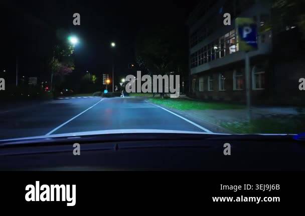 Point of view shot from inside a car driving on a deserted urban road ...