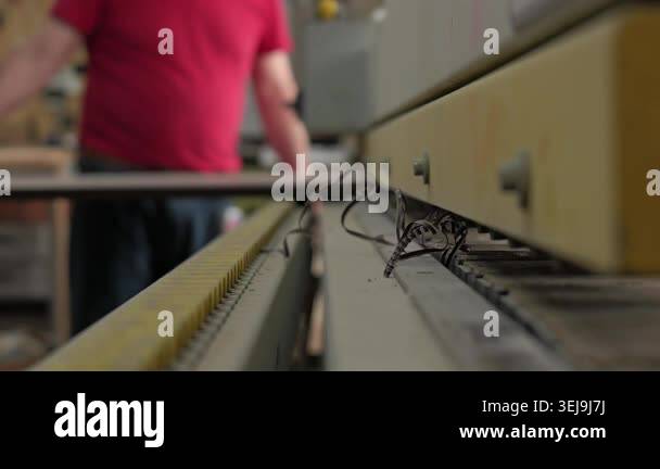 Detailed view of a wood panel processing on an industrial straight line ...