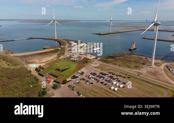 Aerial view of coastal wind turbines, parking area, recreational zone ...