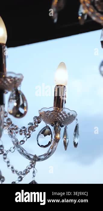 Vertical video. Elegant wedding ceremony chandelier glowing on dark ...