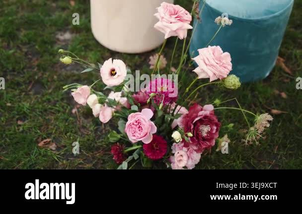 Seminar floral decor on grass near event arch for outdoor business ...