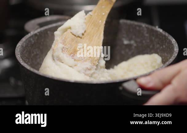 Cooking ghomi, a popular dish from the Samegrelo region made with ...