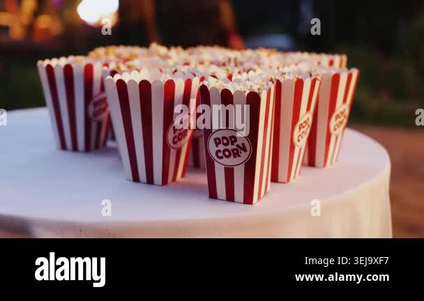 Popcorn boxes on catering table at outdoor wedding party or cinema ...