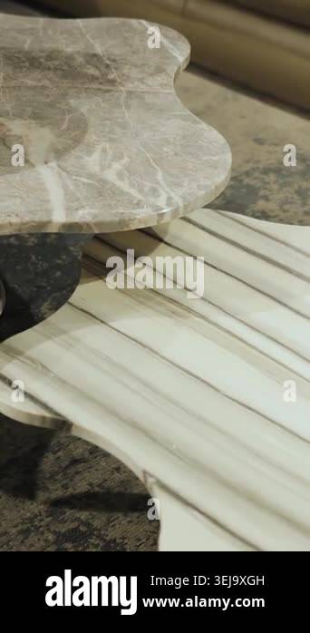 Vertical video. Marble coffee tables in luxury apartment interior with ...