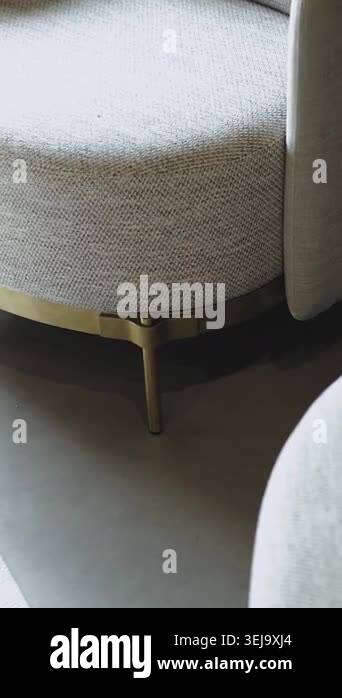Vertical video. Two white chairs with armrests on tiled and concrete ...