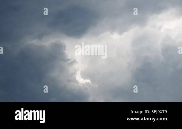 Dark gray clouds roll in as the storm approaches the area. The ...