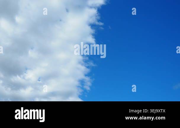 The sky with blue and gray clouds. The camera focuses on the clouds as ...