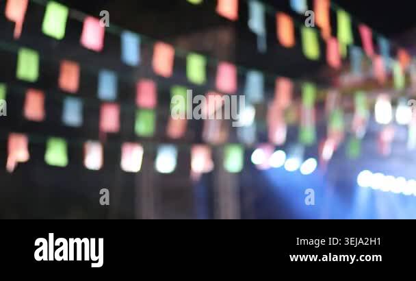 Colorful festival flags with bokeh lights at night, creating a lively ...