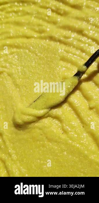 Close-up macro view of bright yellow shimmering salt body scrub texture ...