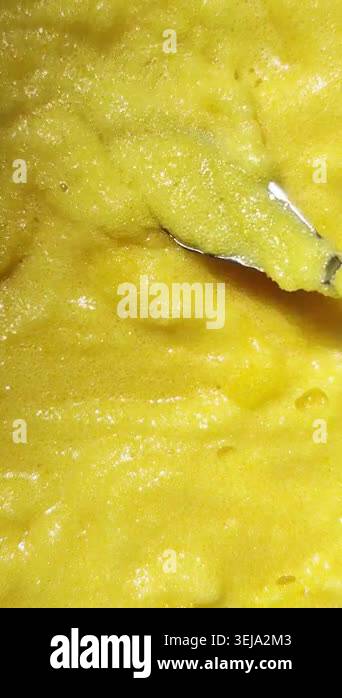 Close-up macro view of bright yellow shimmering salt body scrub texture ...
