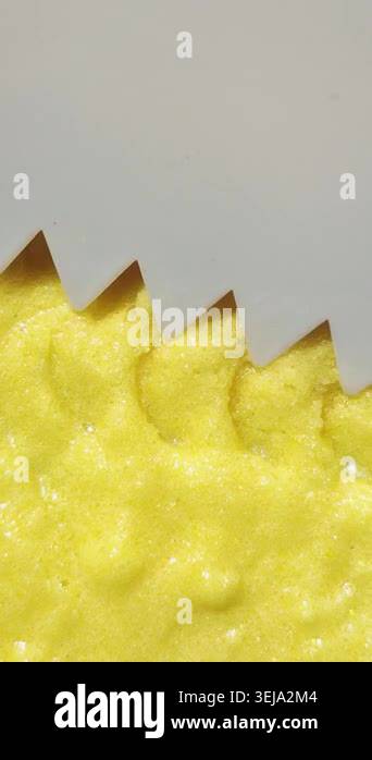 Close-up macro view of bright yellow shimmering salt body scrub texture ...
