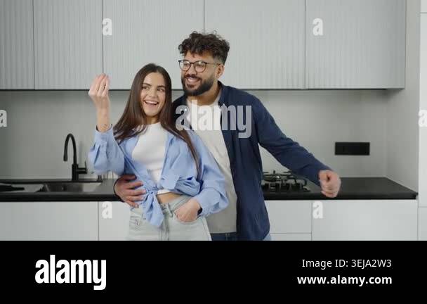 Happy young couple celebrating new home purchase with keys Stock Video ...
