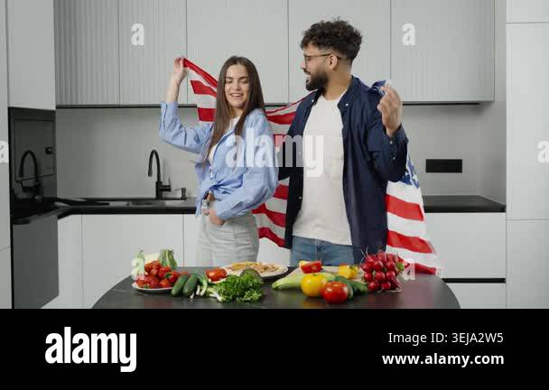 Happy couple dancing with american flag in kitchen Stock Video Footage ...