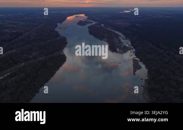 Breathtaking aerial dawn view of a winding river with forested banks ...