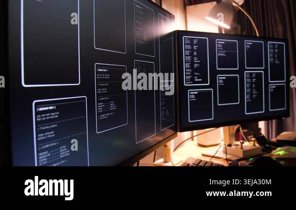 Close up computer monitors displaying fictional programming code and ...