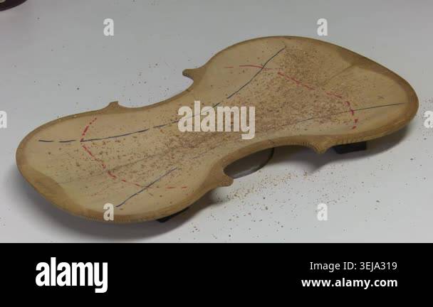 Bilbao, spain; may 21 2022: wooden back plate of a violin vibrating and ...