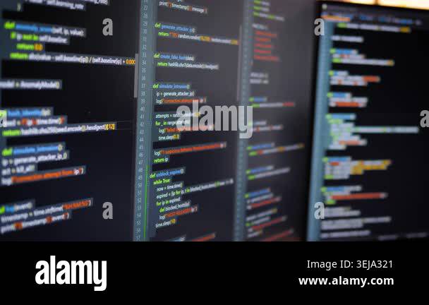 Close up computer monitors displaying fictional programming code and ...