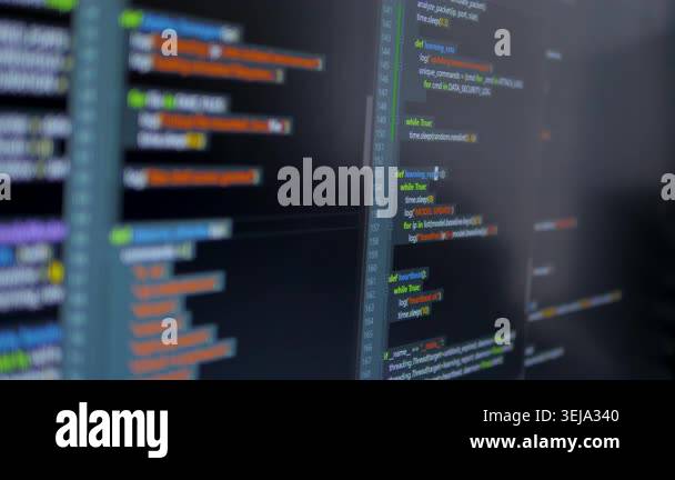 Close up computer monitors displaying fictional programming code and ...