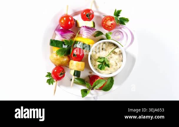 grilled vegetable skewers with dipping sauce on white background high ...