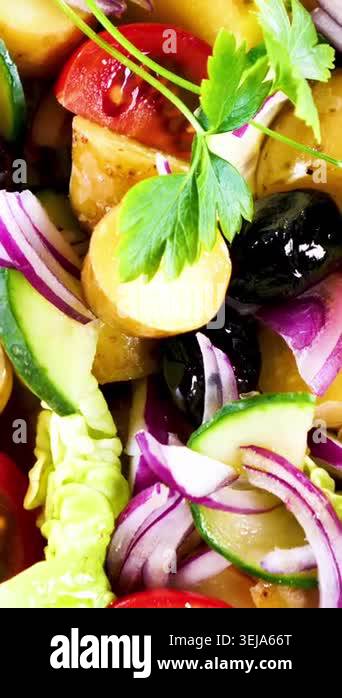 fresh greek salad with red onions olives tomatoes and cucumbers close ...