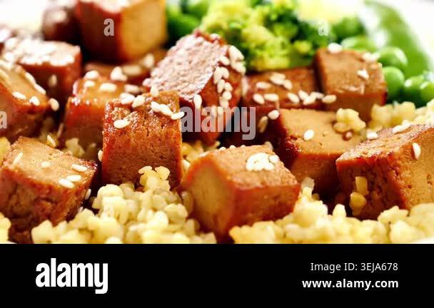 fried tofu cubes with sesame seeds served with brown rice and green ...