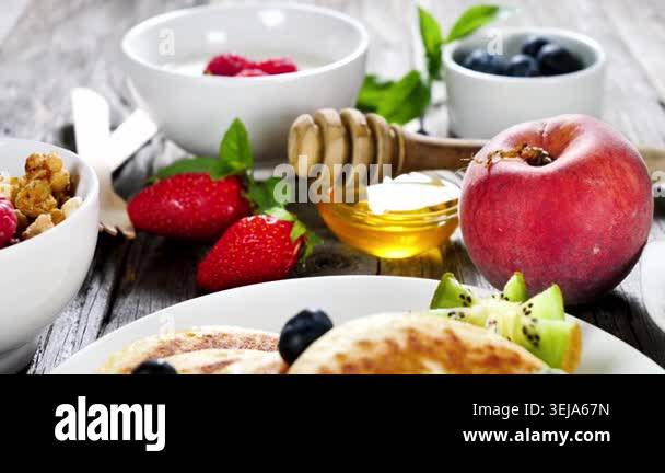 healthy breakfast or brunch meal, fresh pancakes with berries honey and ...