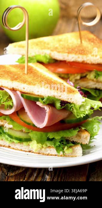 classic club sandwich with ham, cheese, fresh lettuce, cucumber and ...