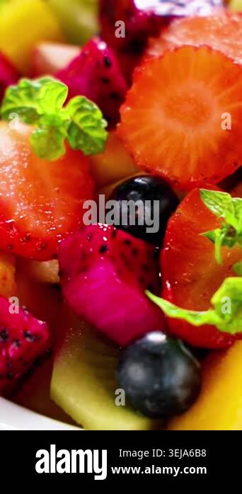 extreme close up of a fresh exotic fruit salad with dragon fruit, kiwi ...