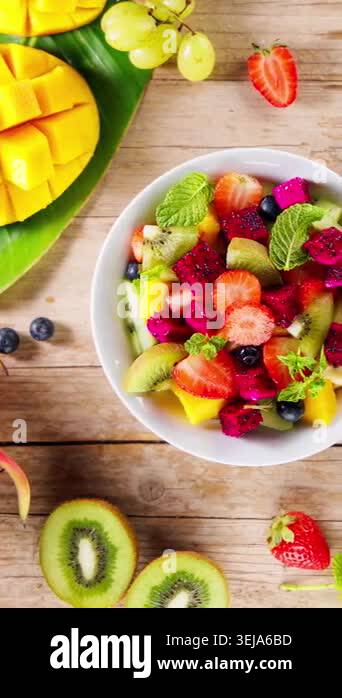 tropical fruit salad with dragon fruit, berries, kiwi and mango in ...