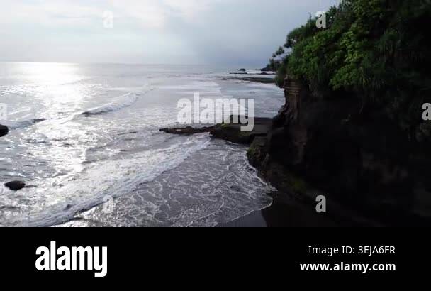 Drone footage captures the coastline of Bali with waves breaking ...