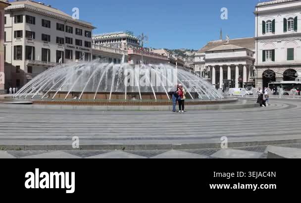 Genoa, Italy - May, 12, 2026. Piazza De Ferrari fountain with tourists ...