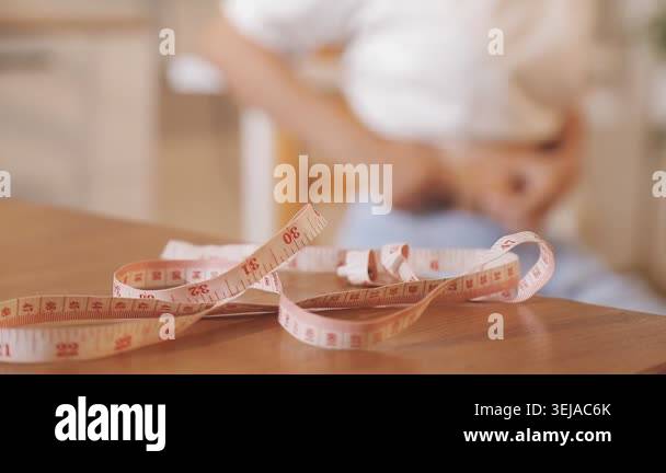 young girl measuring her waist on table Stock Video Footage - Alamy