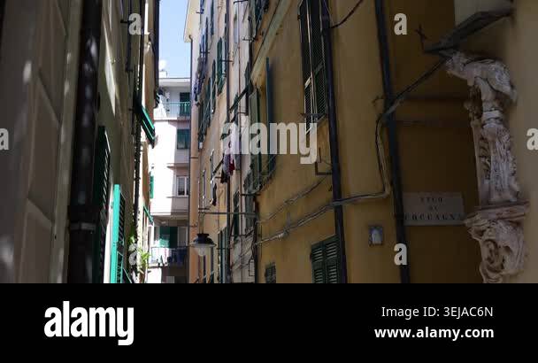 Horizontal cinematic shot of narrow Vico di Coccagna street in Genoa ...