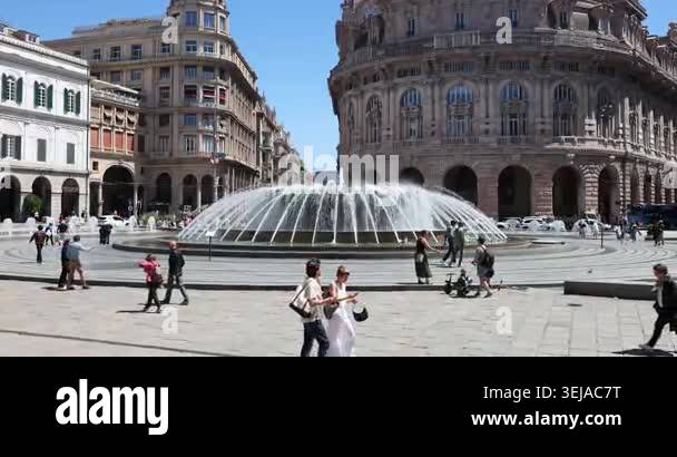 Genoa, Italy - May, 12, 2026. Piazza De Ferrari fountain with tourists ...