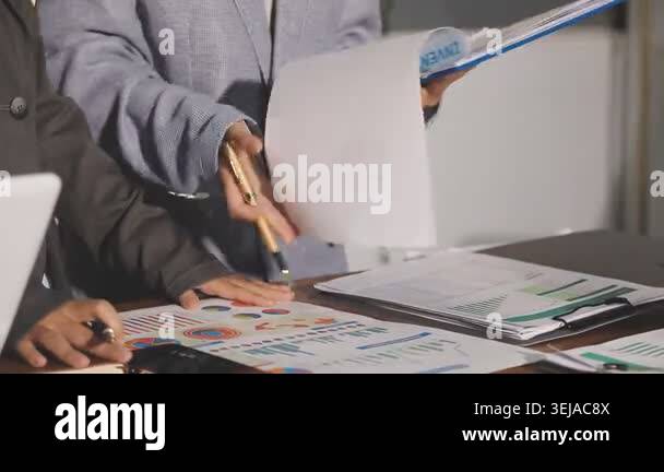 business man working with financial report and laptop at the office ...