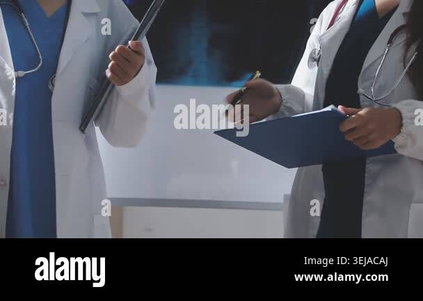 doctor in uniform and medical gown discussing x - ray Stock Video ...