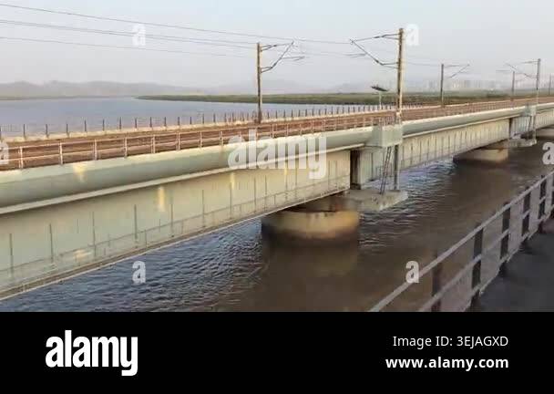 Scenic View of Railway Bridge and Electric Lines Over River Stock Video ...