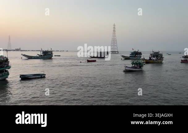 Fishing boats anchored in sea near electric tower Stock Video Footage ...