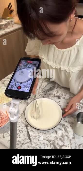 Focused asian woman influencer recording food vlog with smartphone on ...