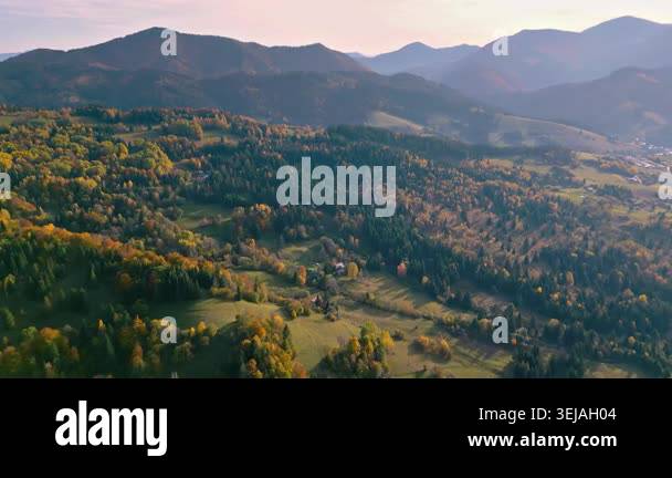 Aerial view of a colorful autumn forest stretching across a peaceful ...