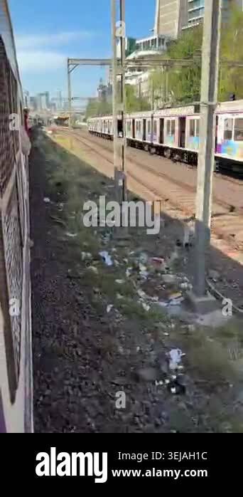 Two Mumbai local trains crossing each other at a suburban railway ...