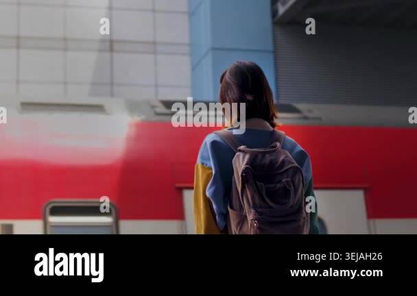 A girl with a backpack waits on a train platform, a city scene with a ...